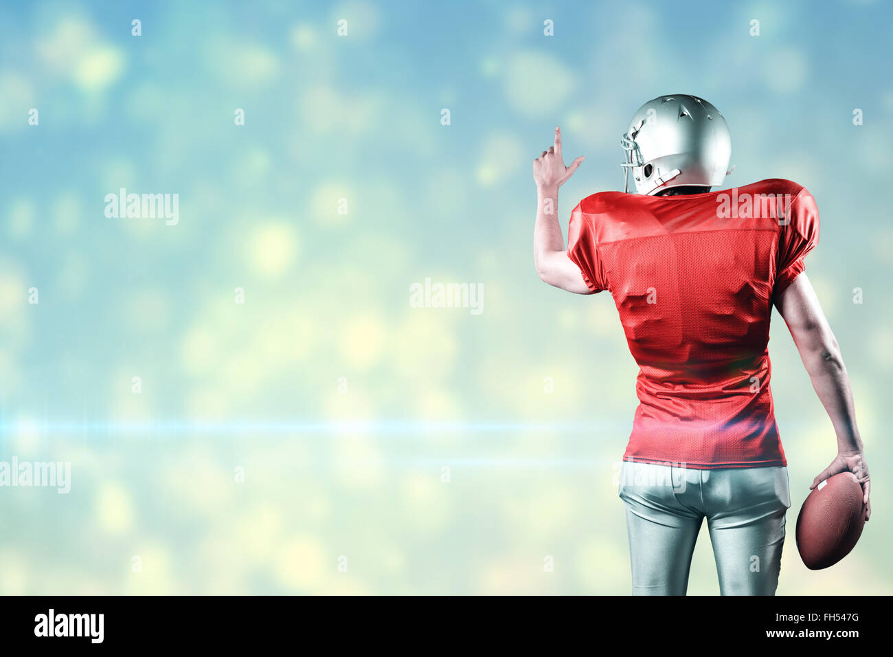 Composite image of rear view of american football player pointing while ...