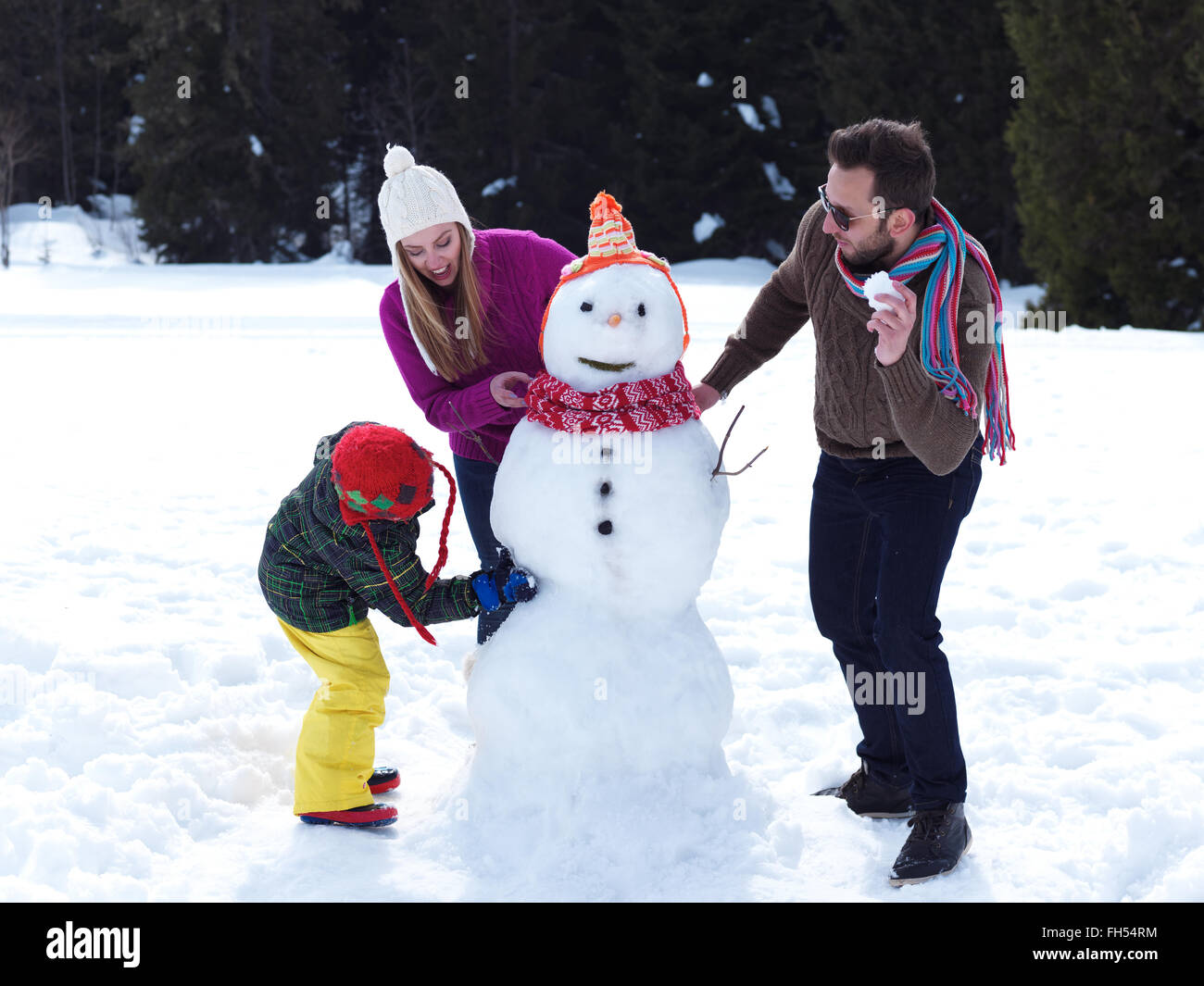 happy family making snowman Stock Photo - Alamy
