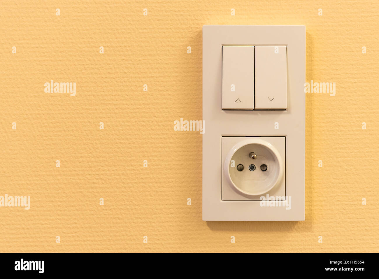 light switch and socket in frame on the wall Stock Photo - Alamy