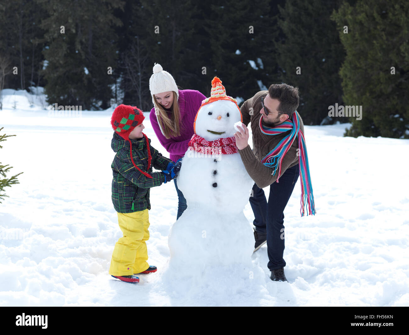 happy family making snowman Stock Photo - Alamy