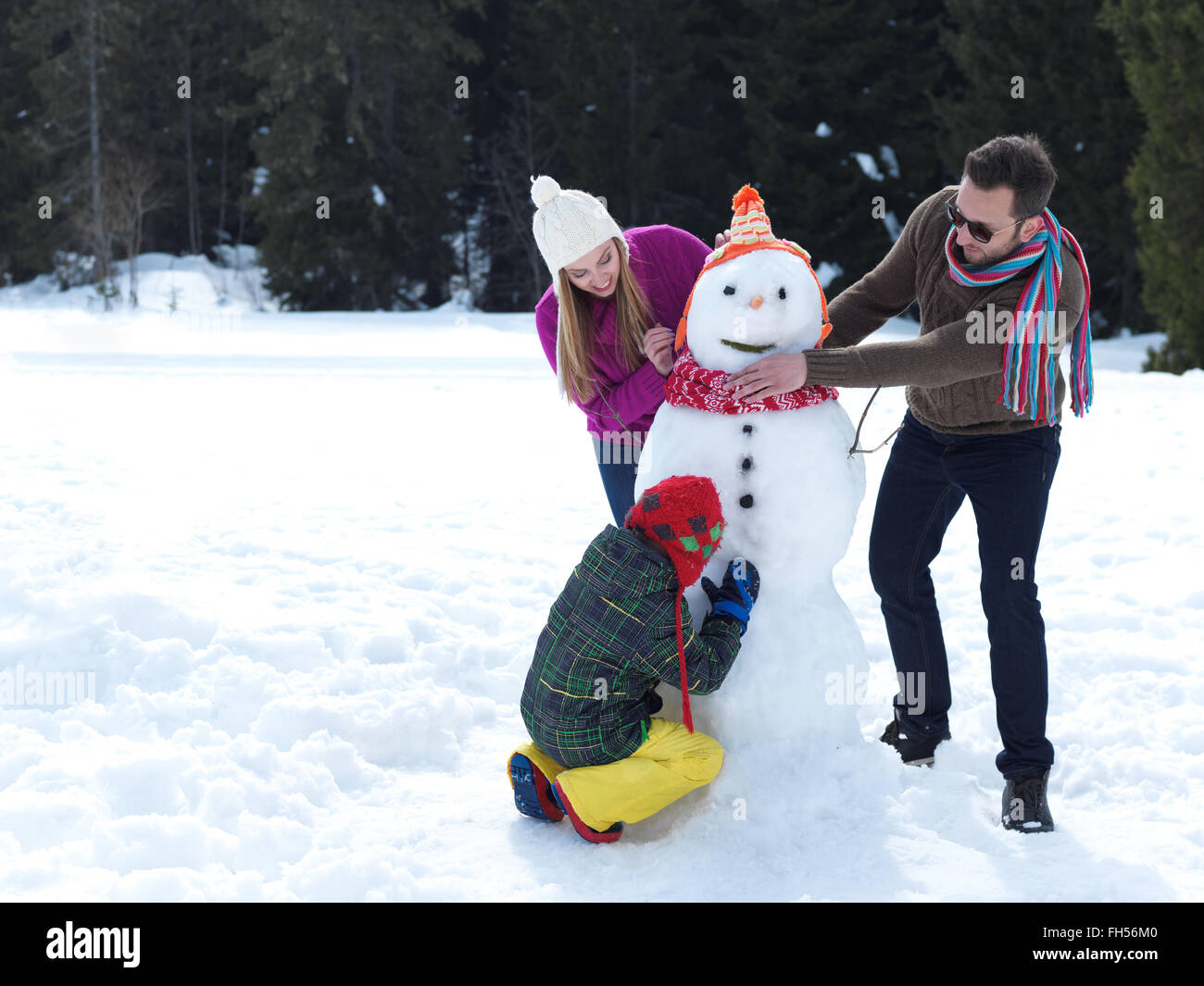 happy family making snowman Stock Photo - Alamy