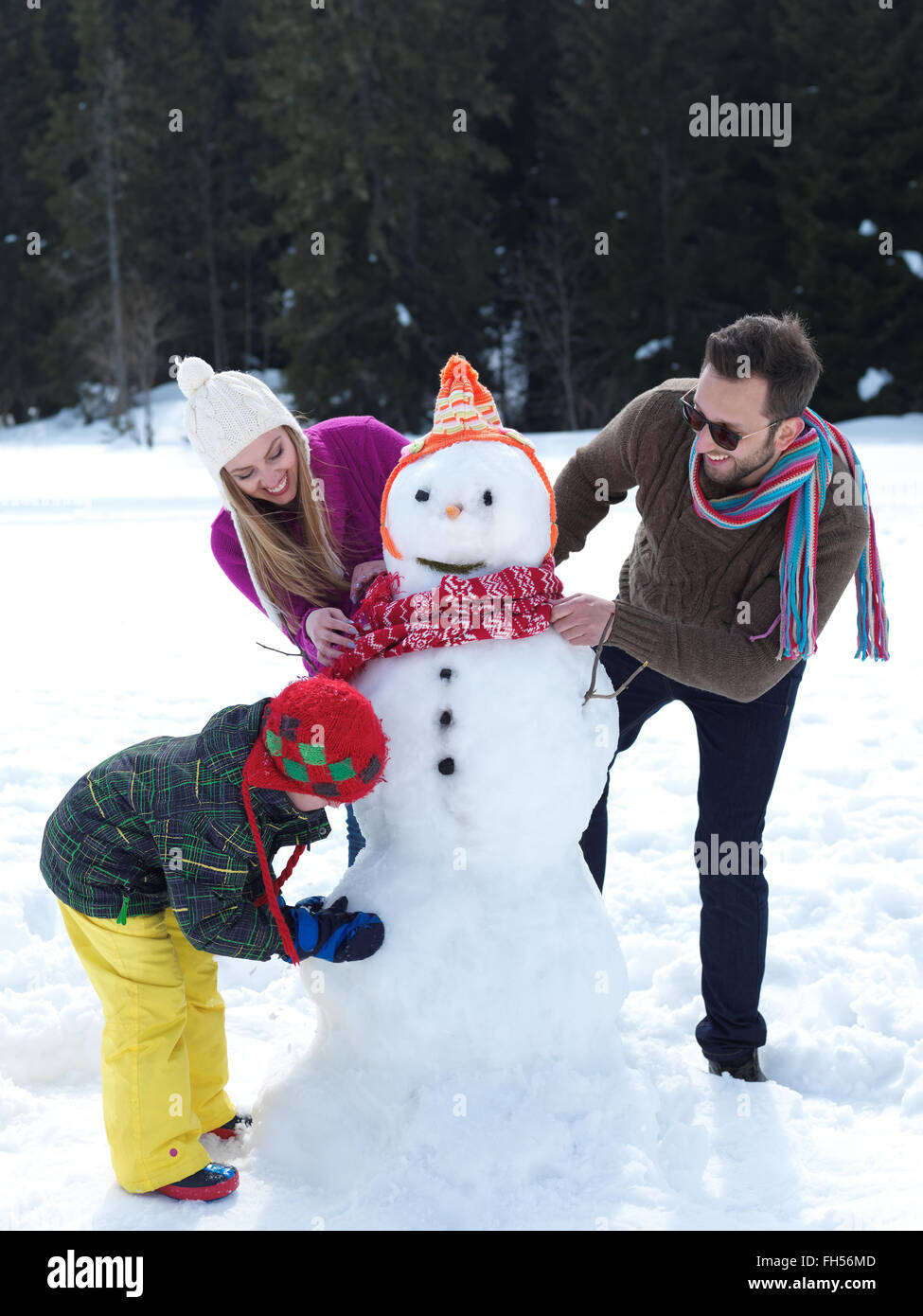 happy family making snowman Stock Photo - Alamy