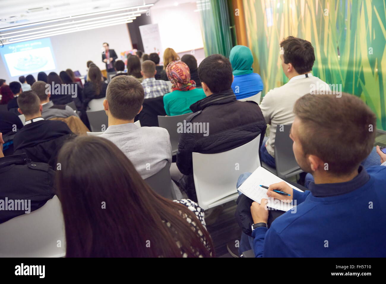 Young student taking notes interview hi-res stock photography and ...