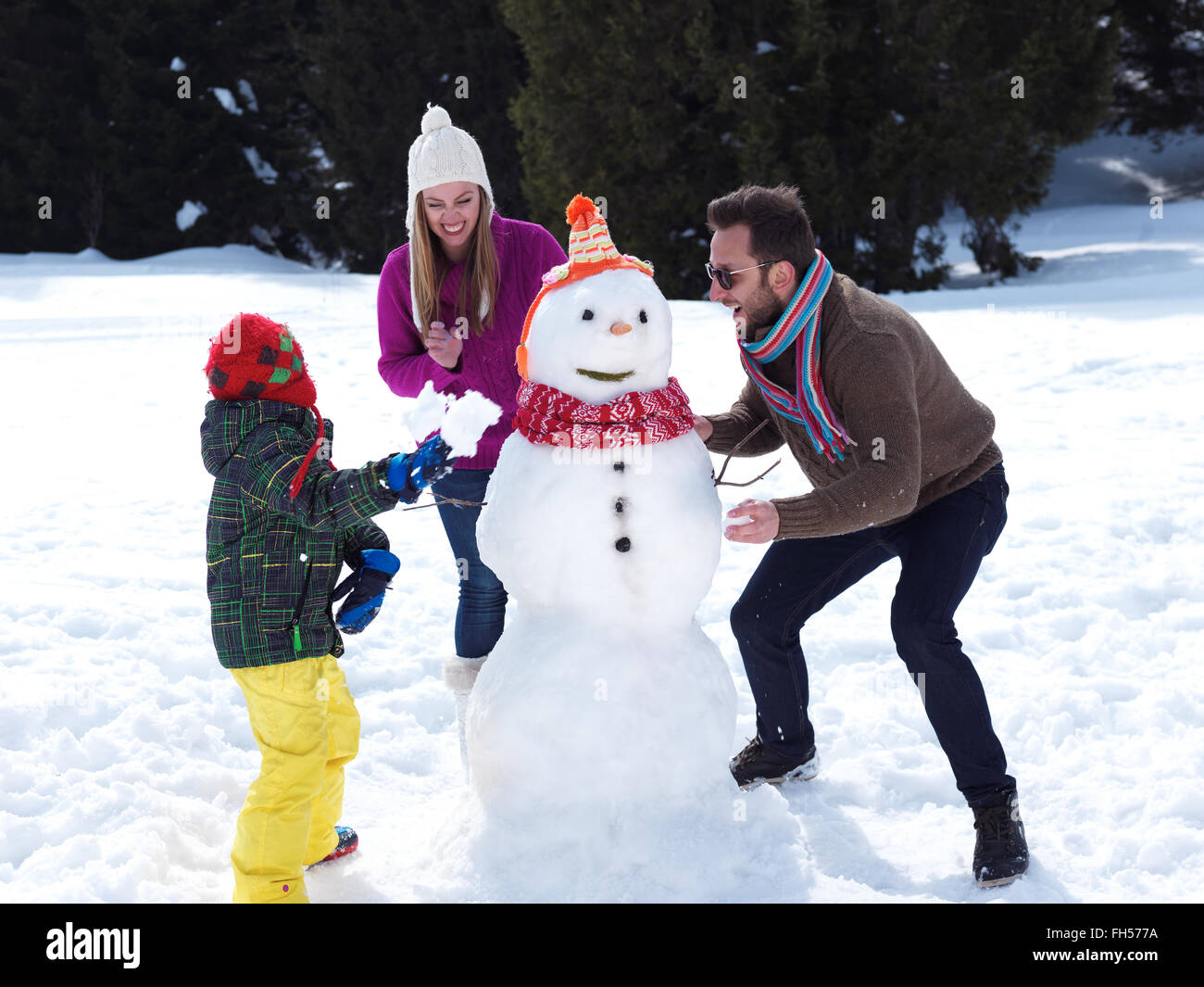happy family making snowman Stock Photo - Alamy