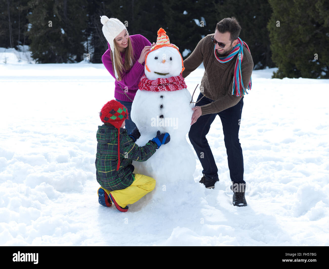 happy family making snowman Stock Photo - Alamy