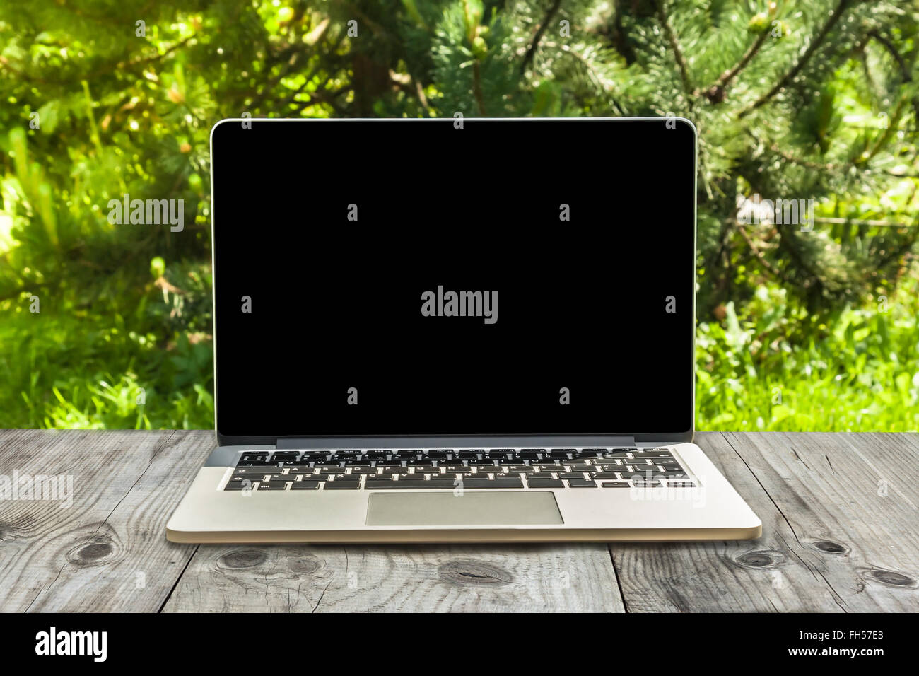 laptop computer on wood workspace and park background Stock Photo - Alamy