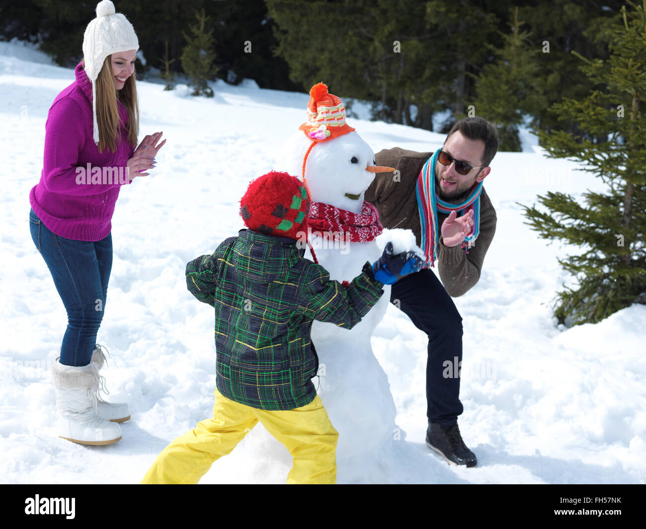happy family making snowman Stock Photo - Alamy