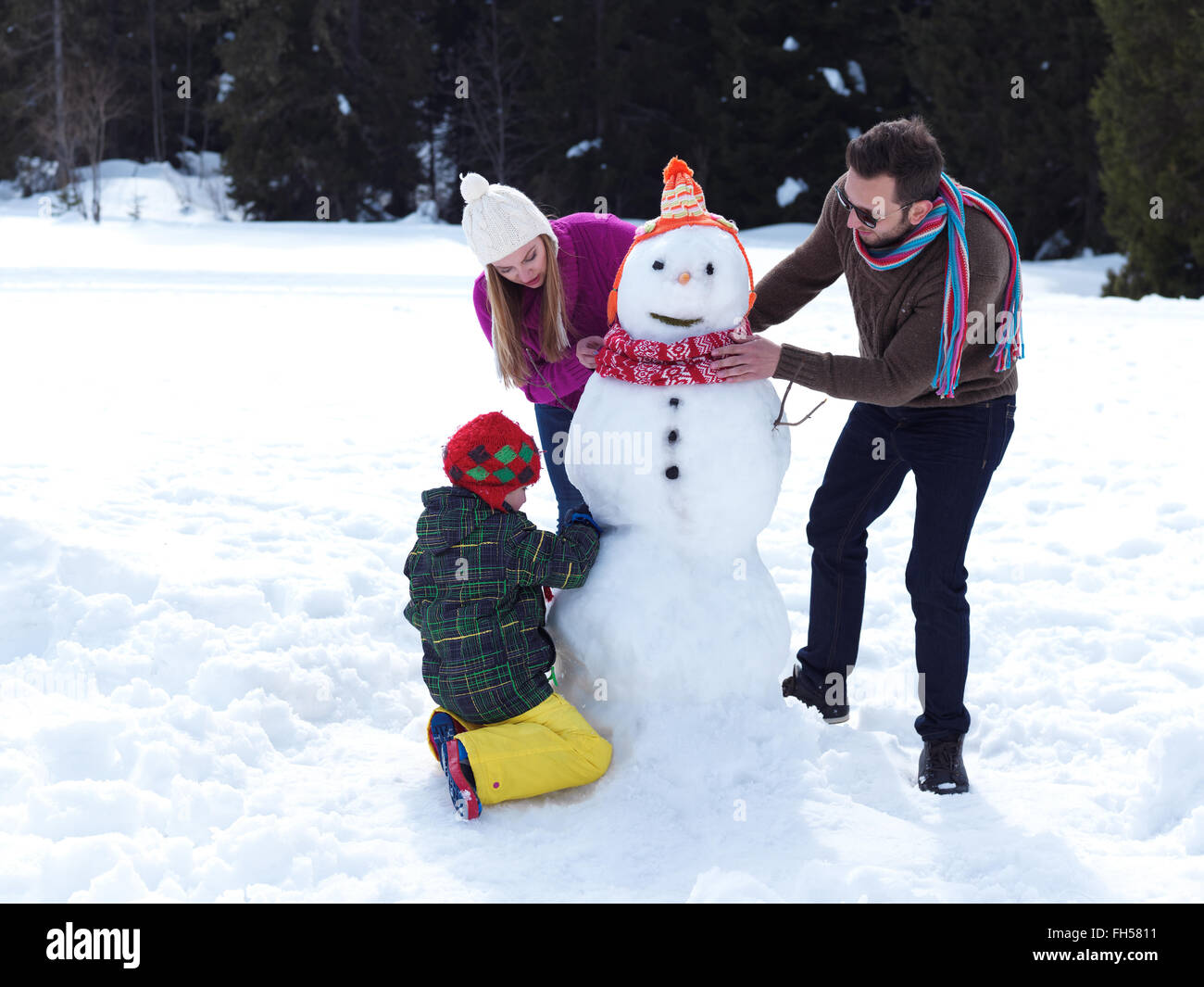 happy family making snowman Stock Photo - Alamy