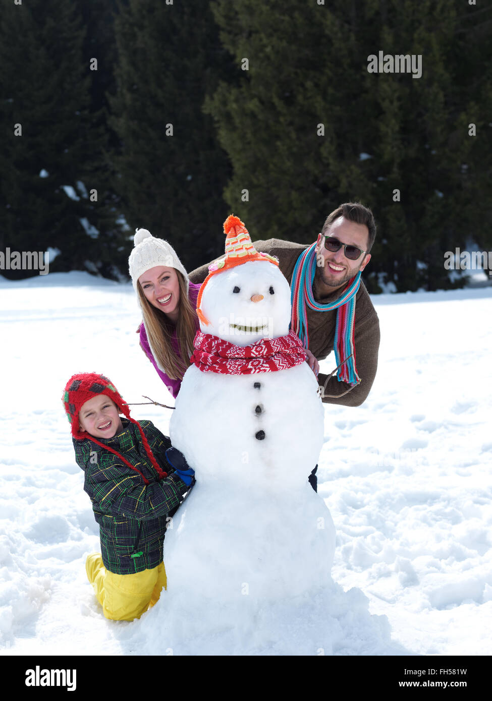 happy family making snowman Stock Photo - Alamy