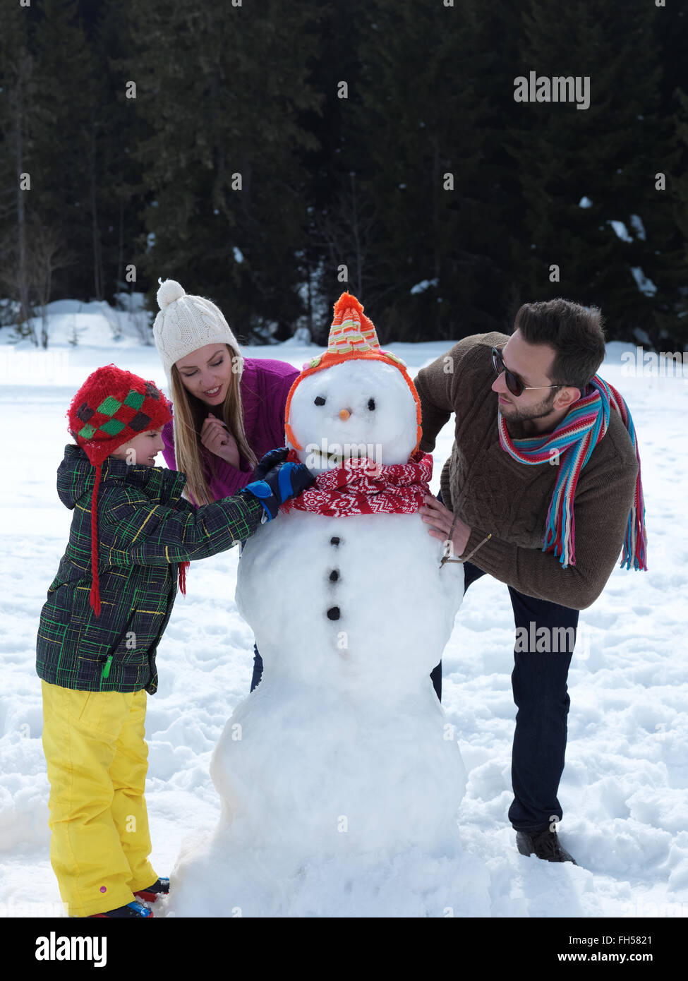 happy family making snowman Stock Photo - Alamy