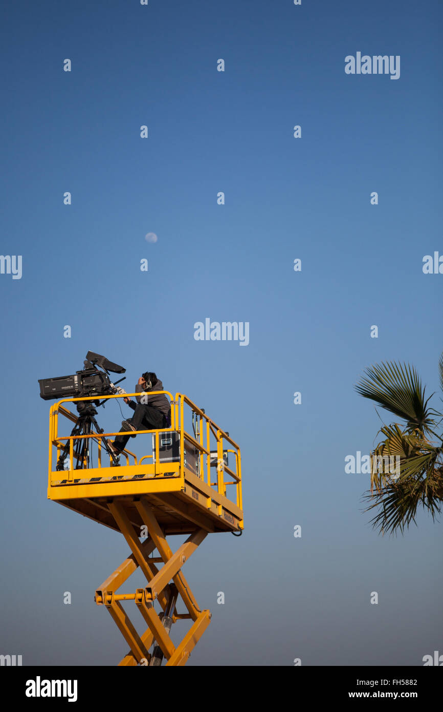 Cameraman filming Sports Day in Doha, Qatar. Moon in background Stock ...
