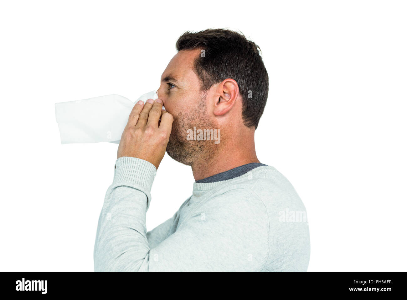 Man blowing his nose Stock Photo - Alamy