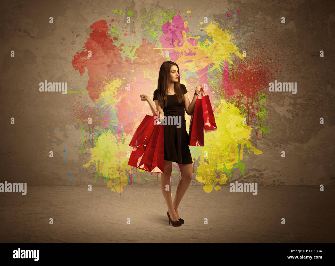 Girl with shopping bags and paint splatter Stock Photo - Alamy