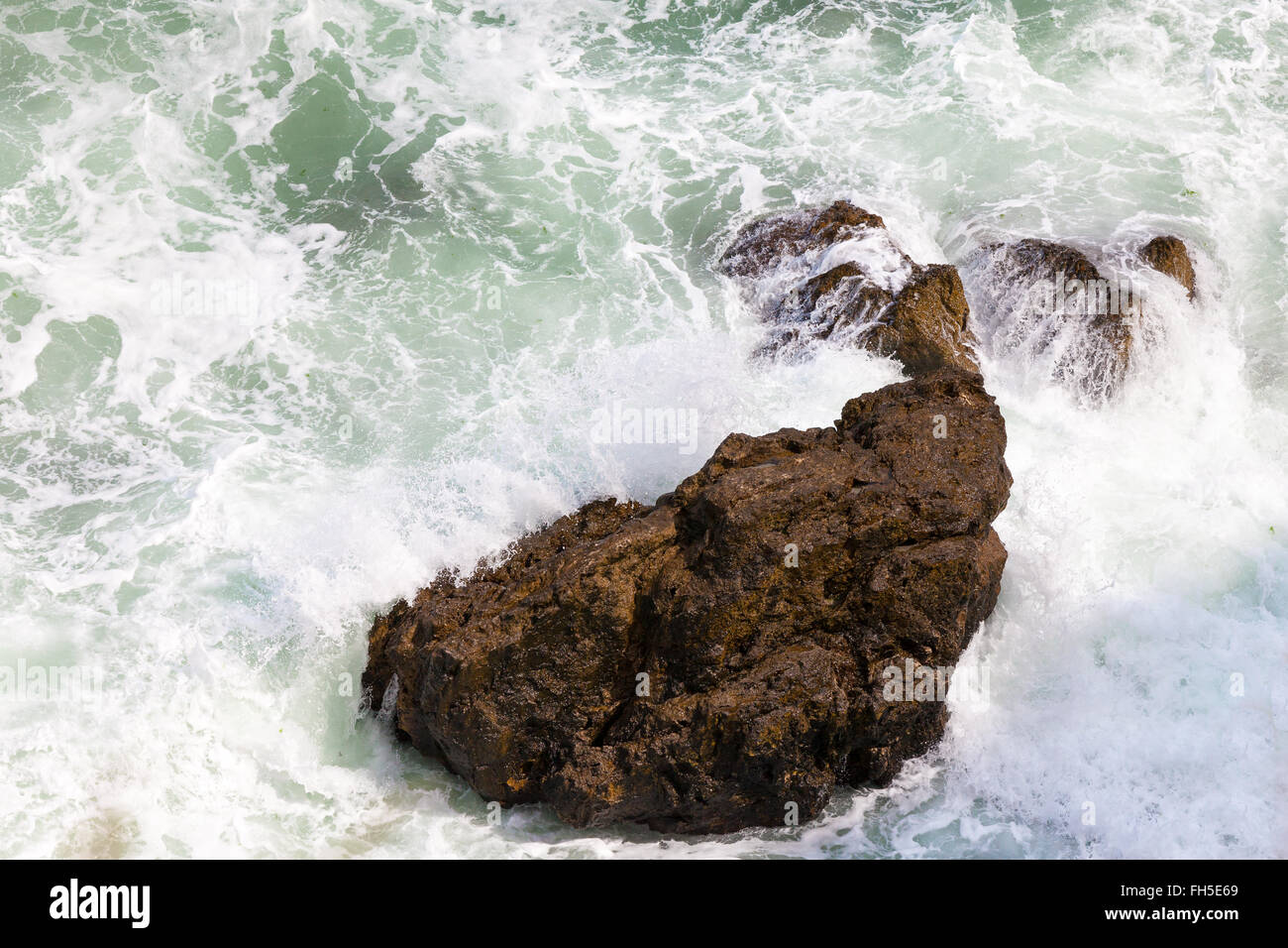 Rock and waves Stock Photo - Alamy