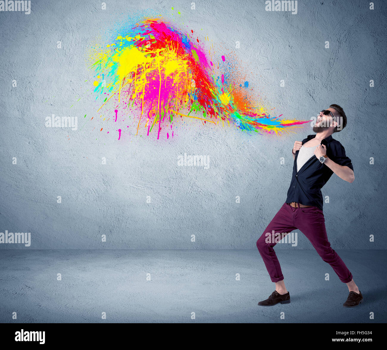 Hipster guy shouting colorful paint on wall Stock Photo - Alamy