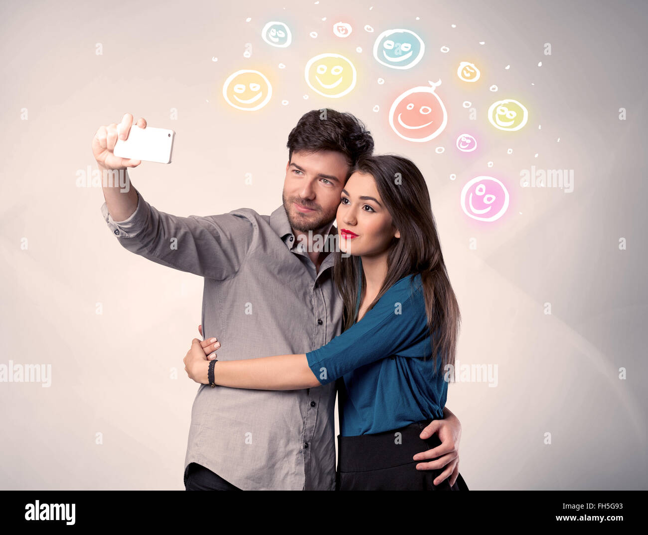 Happy couple taking selfie with smiley Stock Photo - Alamy