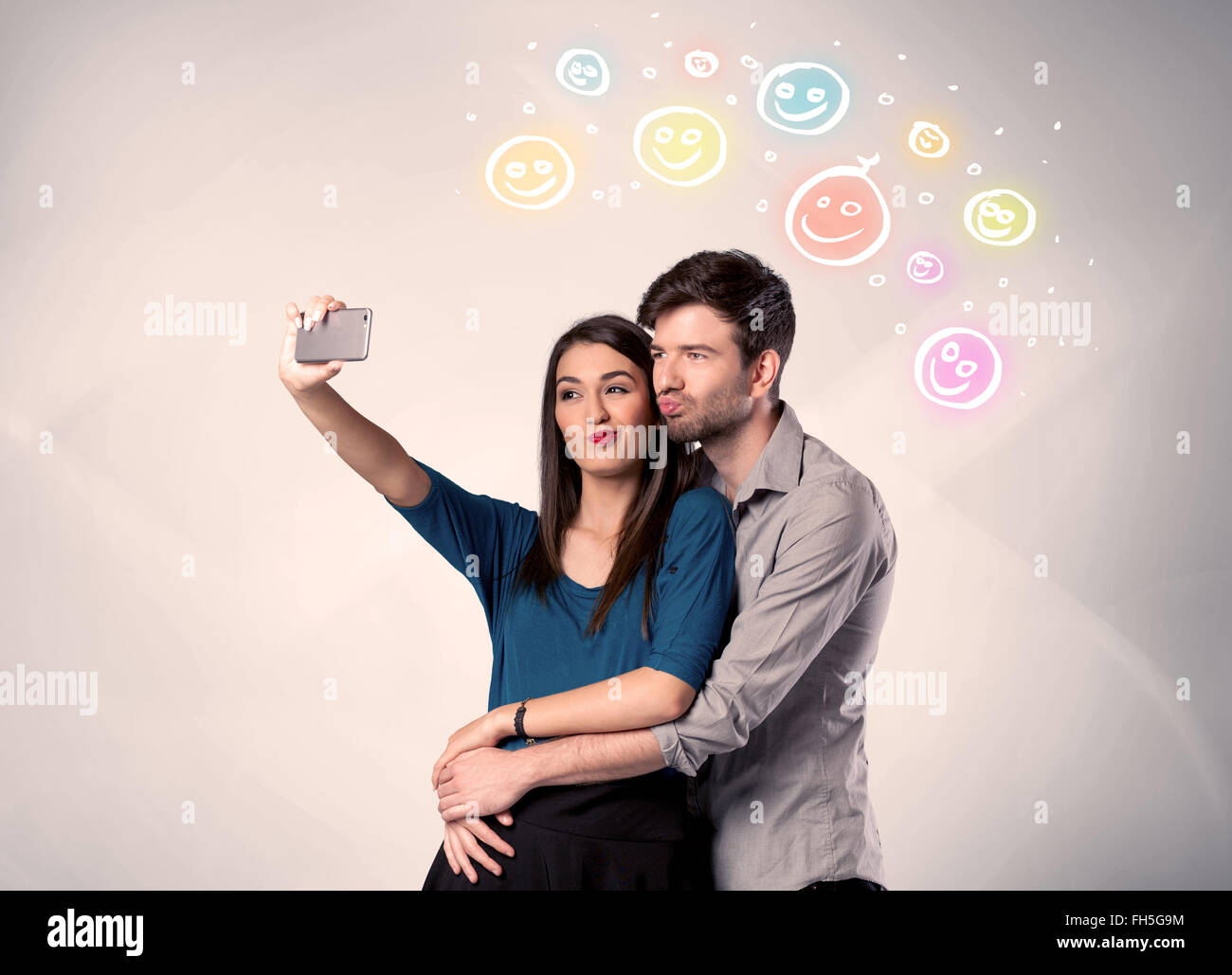 Happy couple taking selfie with smiley Stock Photo - Alamy