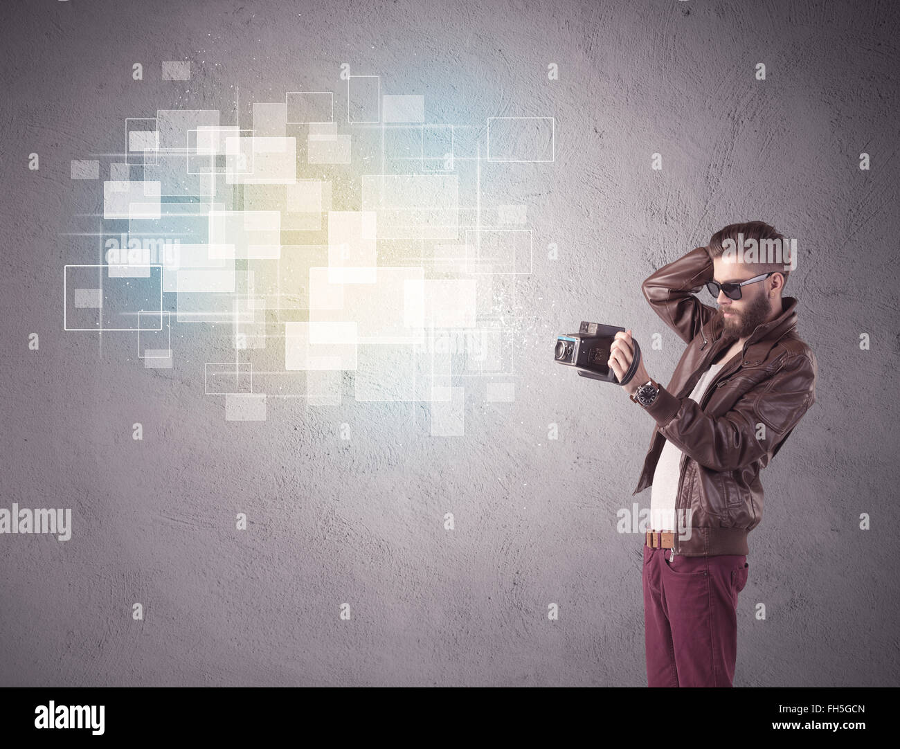 Hipster guy with retro camera in action Stock Photo - Alamy