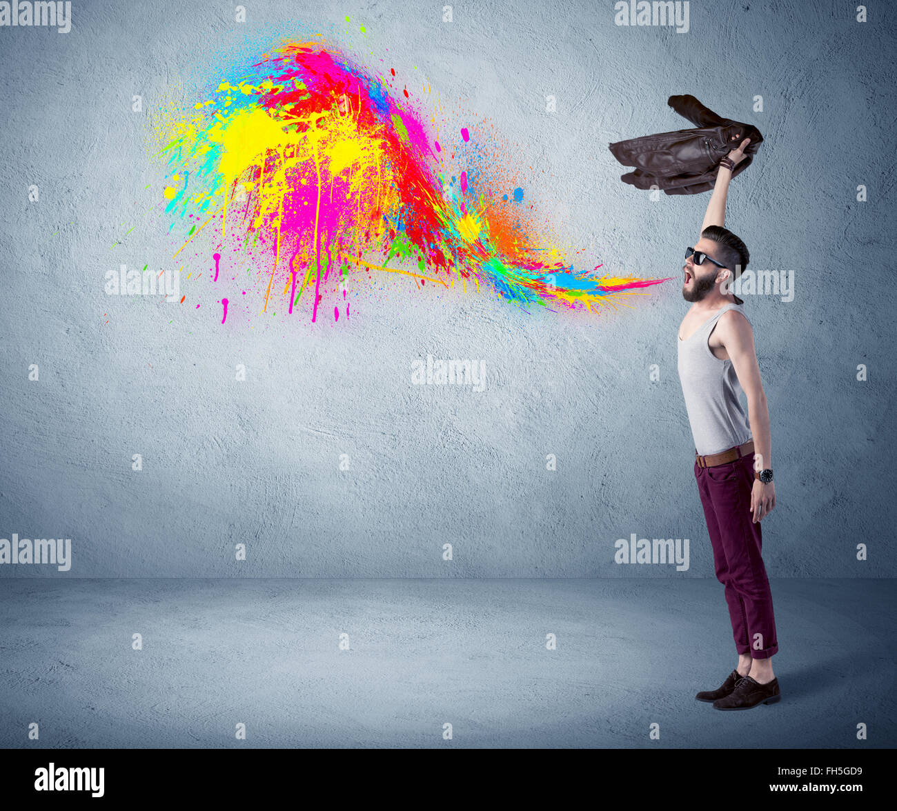 Hipster guy shouting colorful paint on wall Stock Photo - Alamy