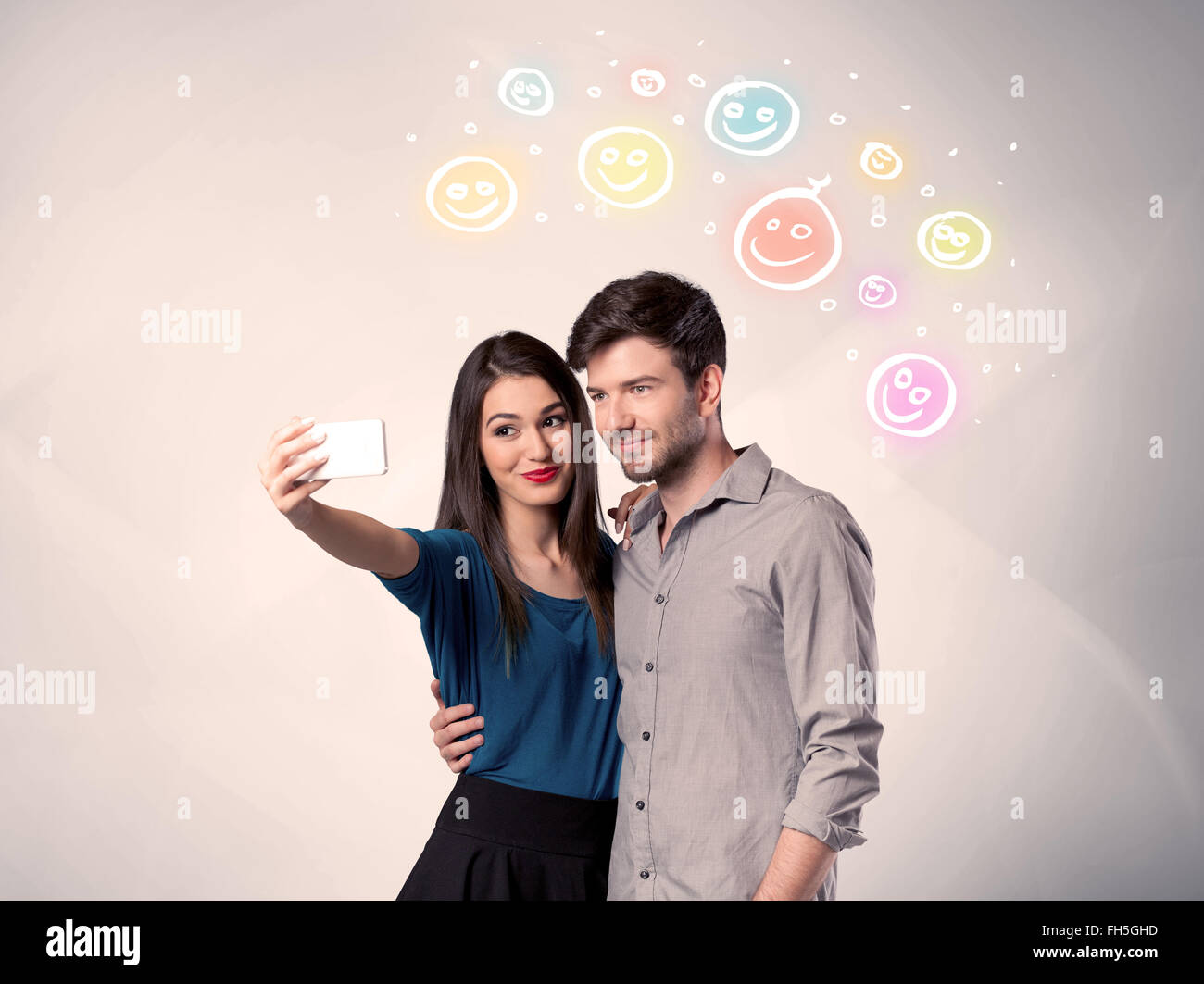 Happy couple taking selfie with smiley Stock Photo - Alamy