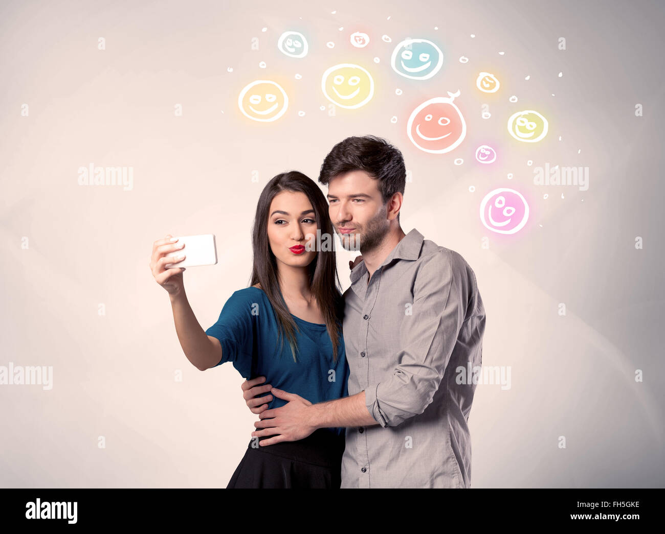 Happy couple taking selfie with smiley Stock Photo - Alamy