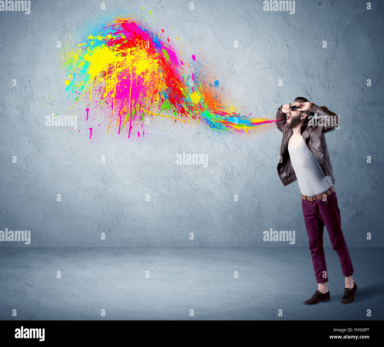 Hipster guy shouting colorful paint on wall Stock Photo - Alamy
