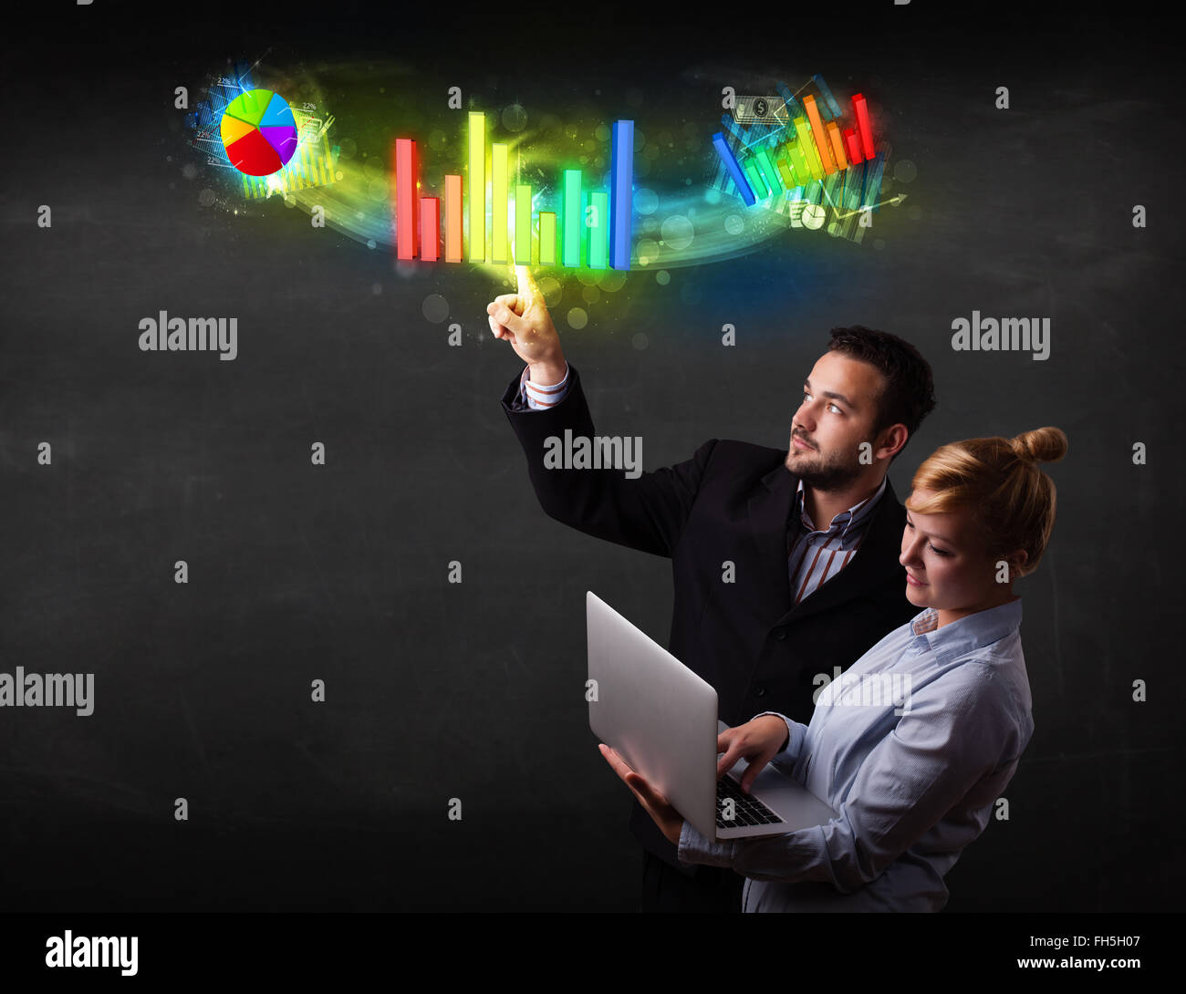 Young business couple touching colorful modern graph system concept ...