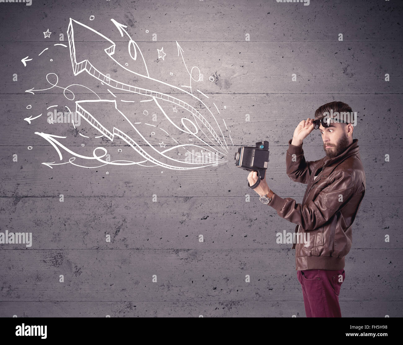 Funny guy taking photos with retro camera Stock Photo - Alamy