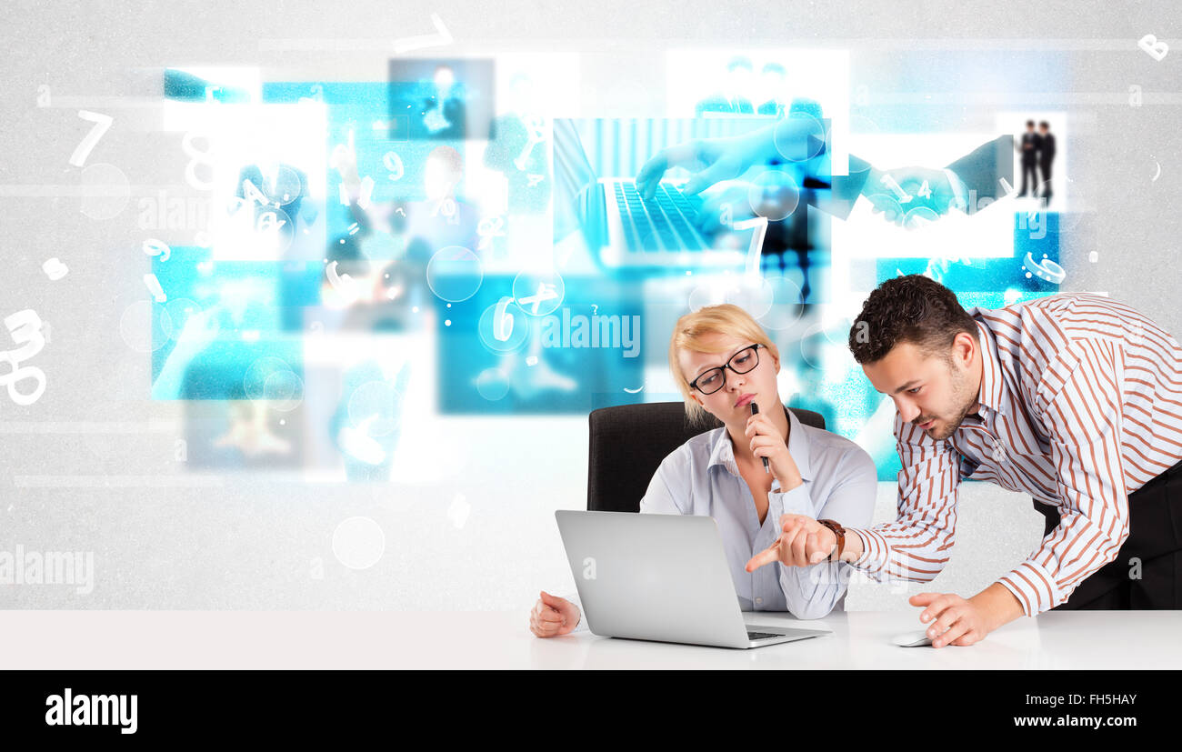 Business persons at desk with modern tech images at background Stock ...