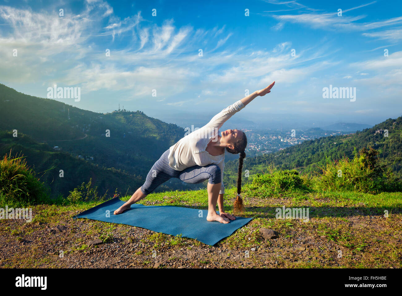 Woman practices yoga asana outdoors Stock Photo - Alamy
