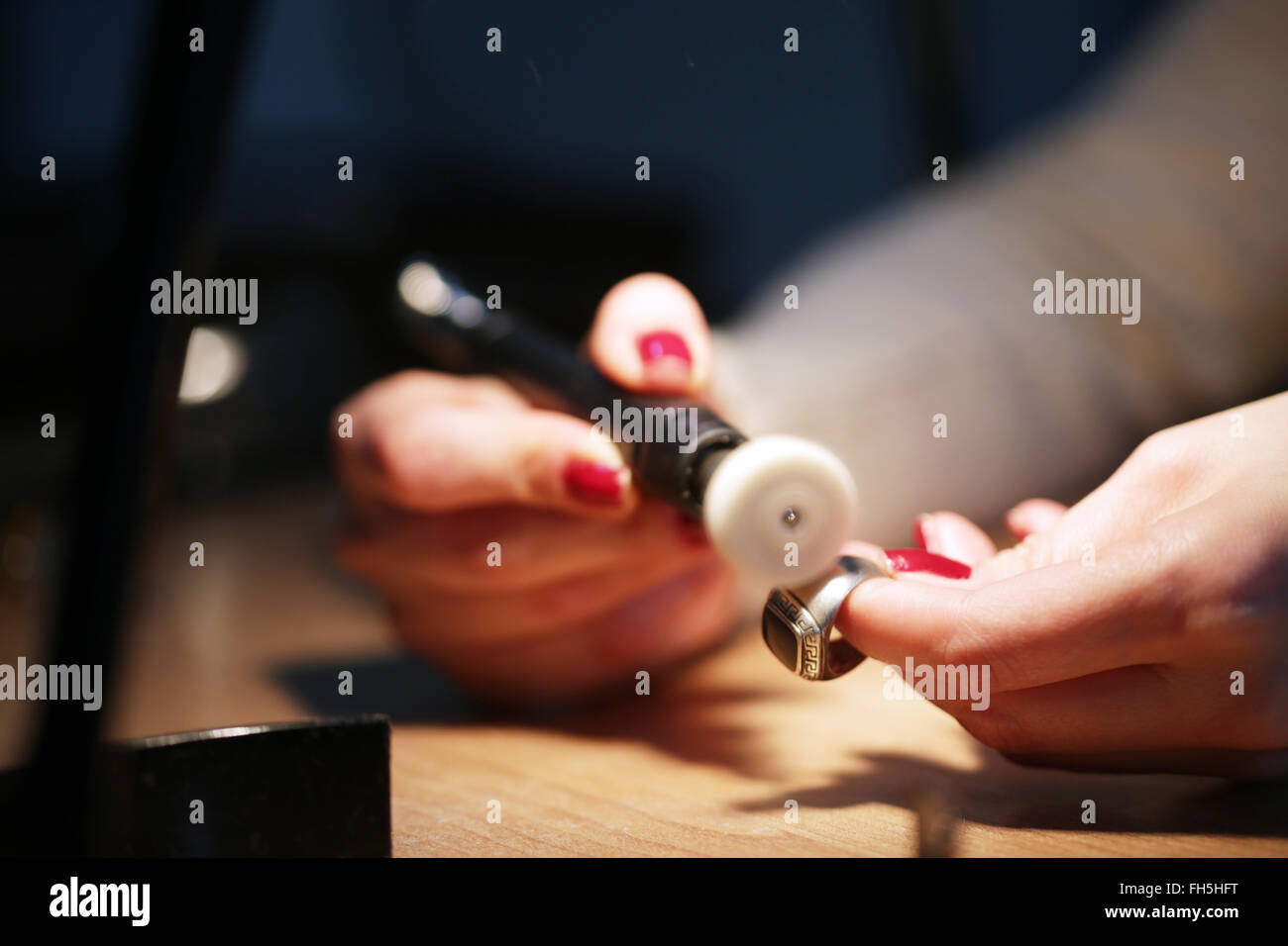 Woman Jeweller prepare a silver ring to polishing Stock Photo - Alamy
