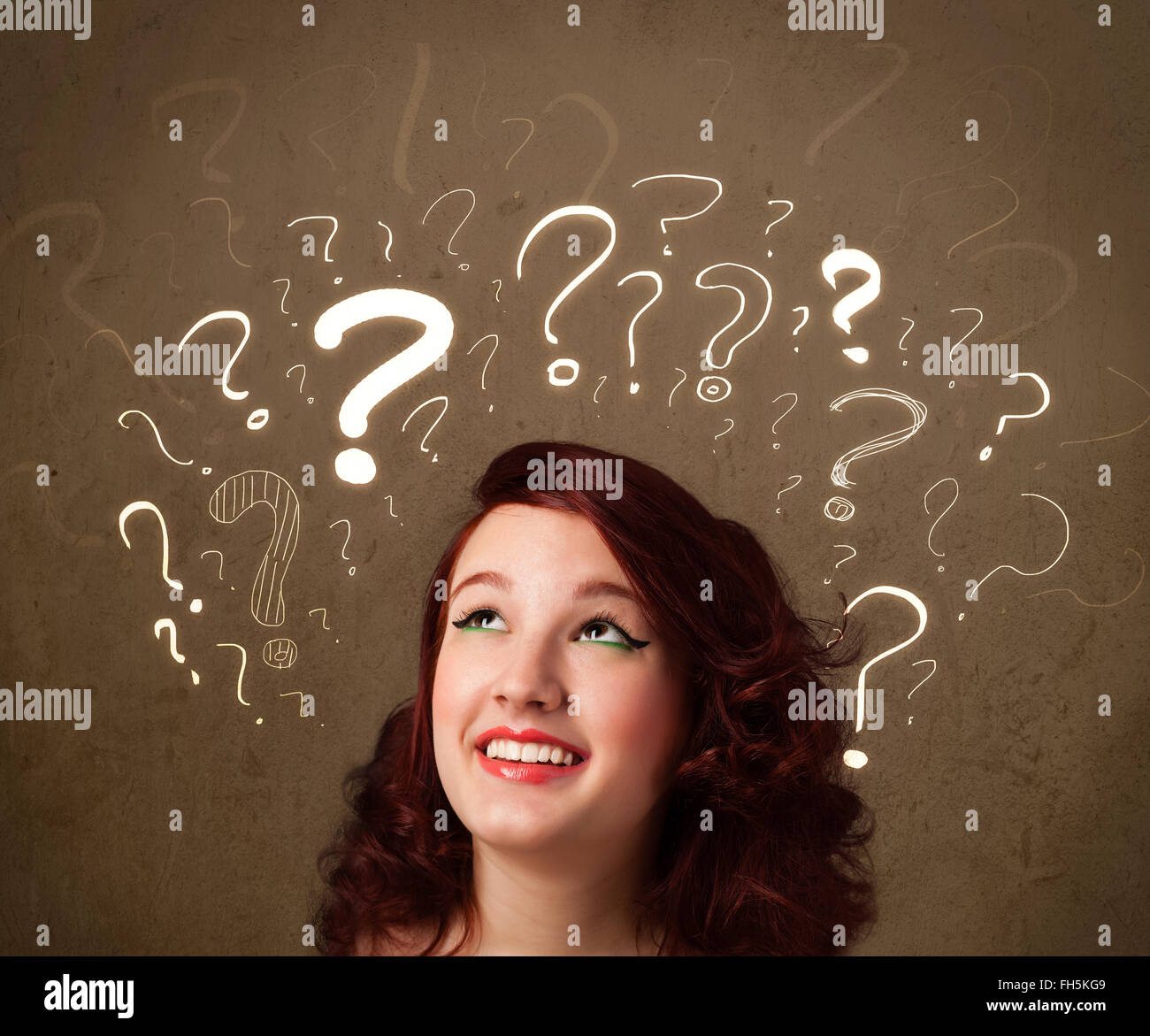 girl with question mark symbols around her head Stock Photo - Alamy