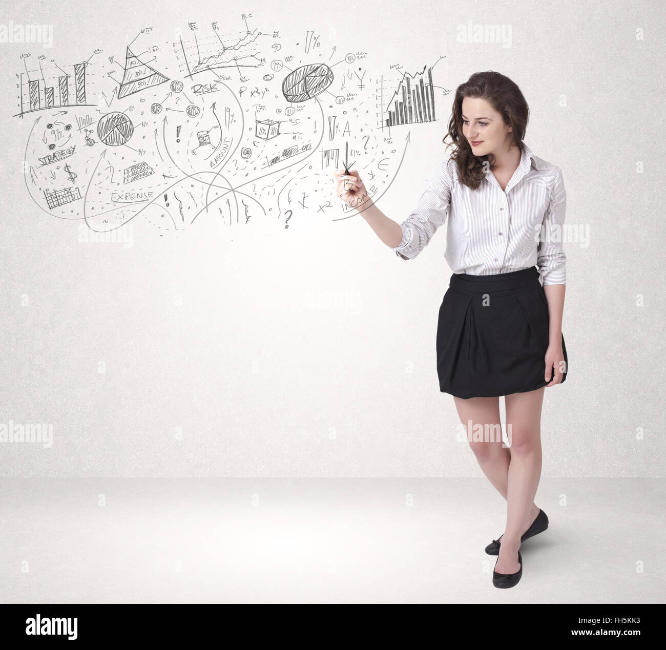 Pretty girl sketching graphs and diagrams on wall Stock Photo - Alamy