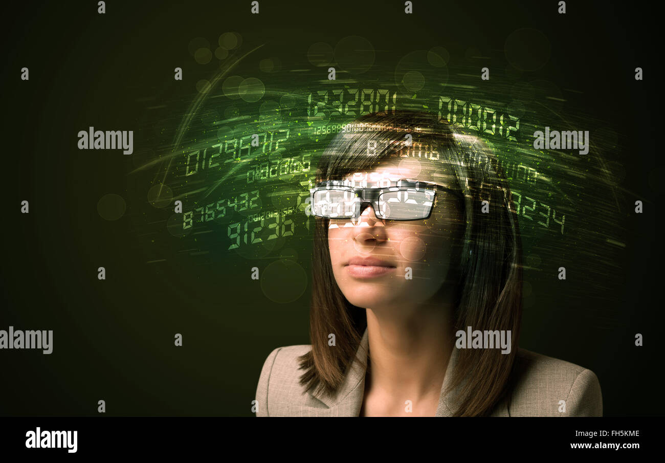 Business woman looking at high tech number calculations Stock Photo - Alamy