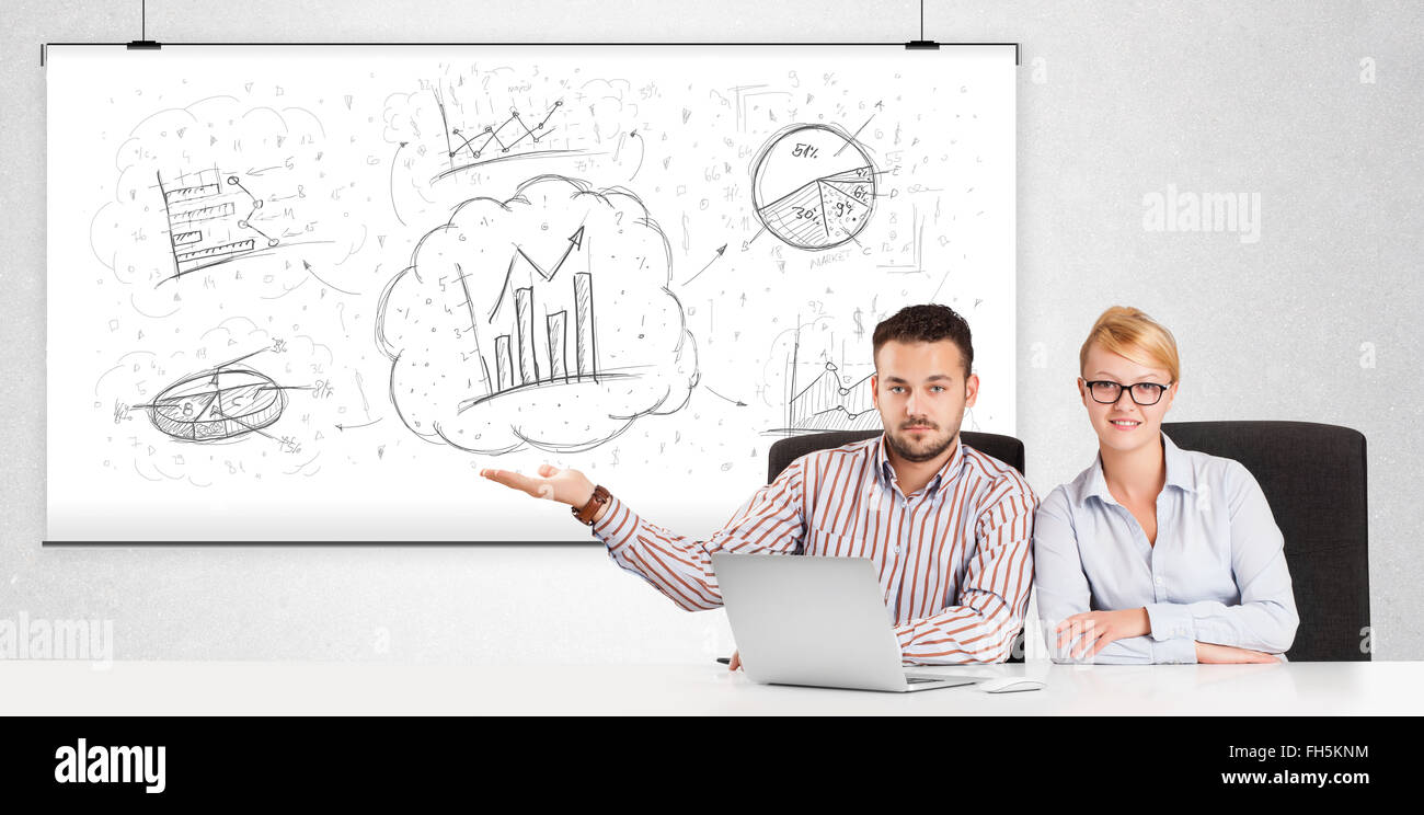Business man and woman sitting at table with hand drawn graph charts ...