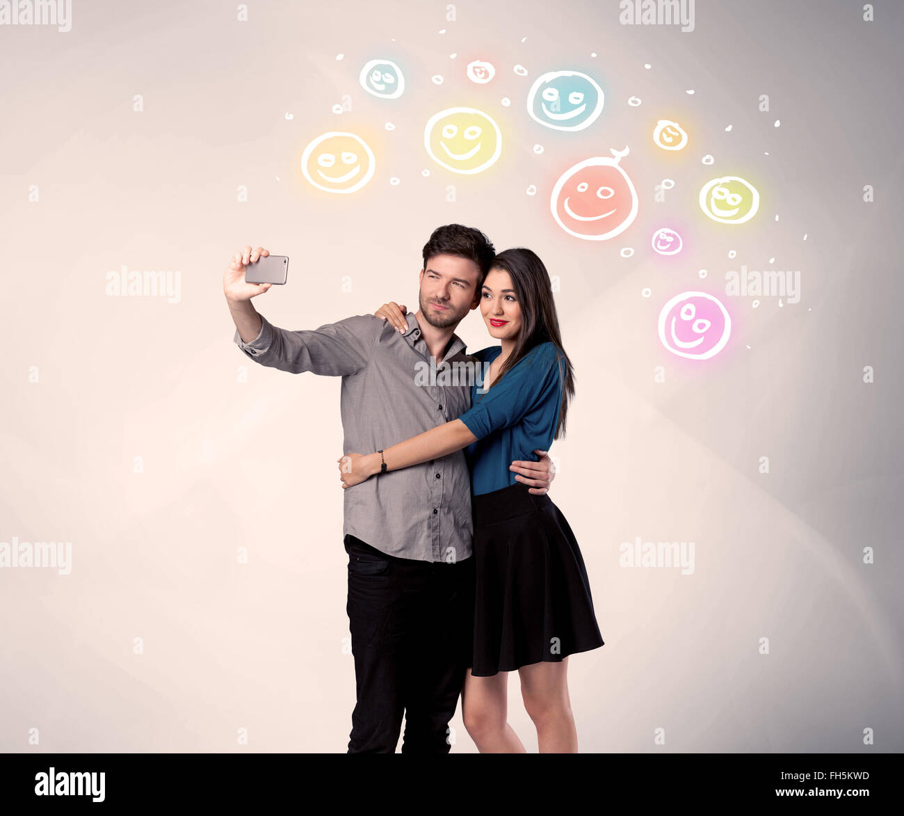 Happy couple taking selfie with smiley Stock Photo - Alamy