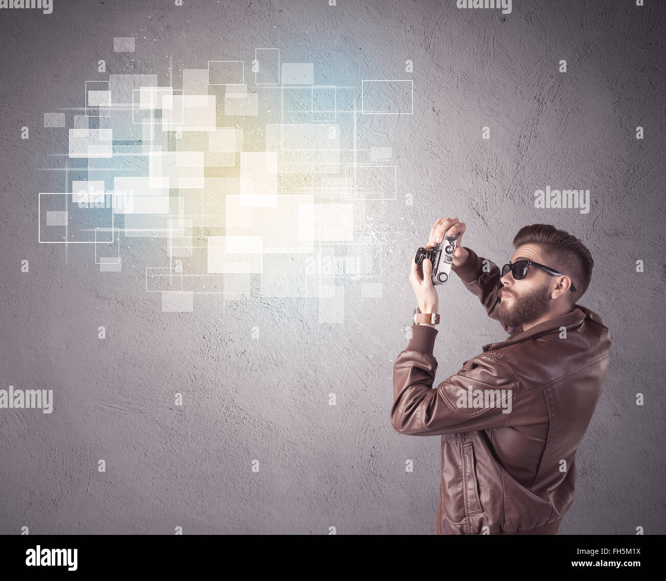 Hipster guy with retro camera in action Stock Photo - Alamy