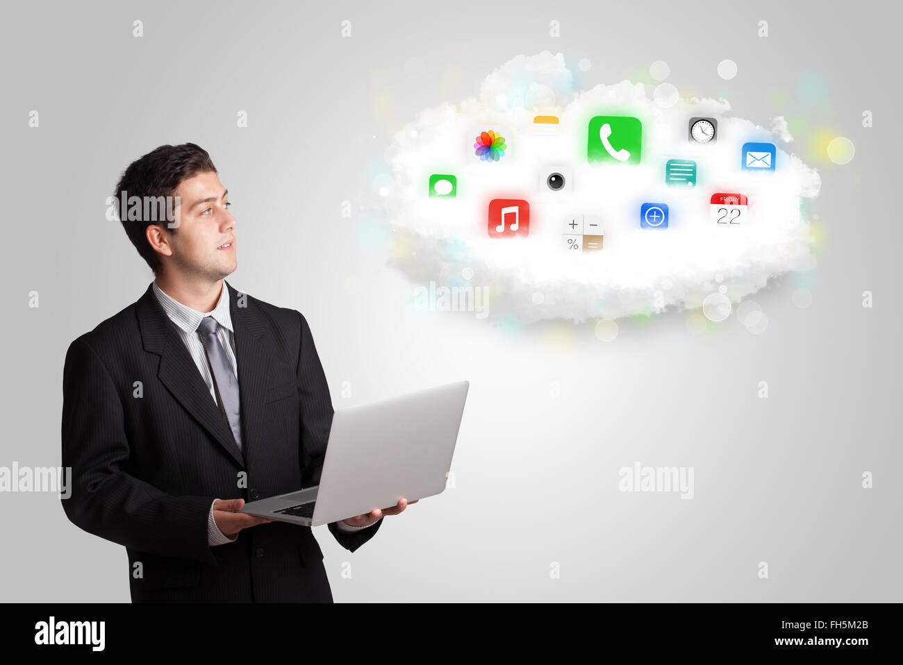 Young man presenting cloud with colorful app icons and symbols Stock ...