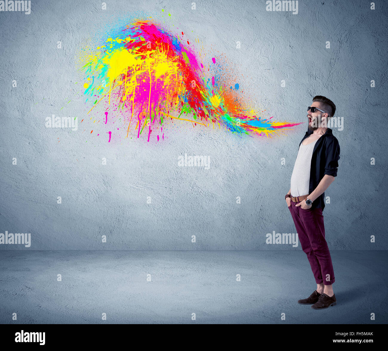 Hipster guy shouting colorful paint on wall Stock Photo - Alamy