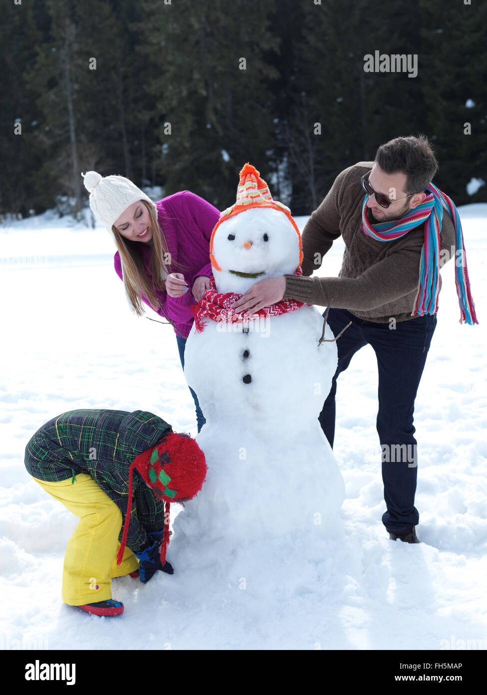 happy family making snowman Stock Photo - Alamy