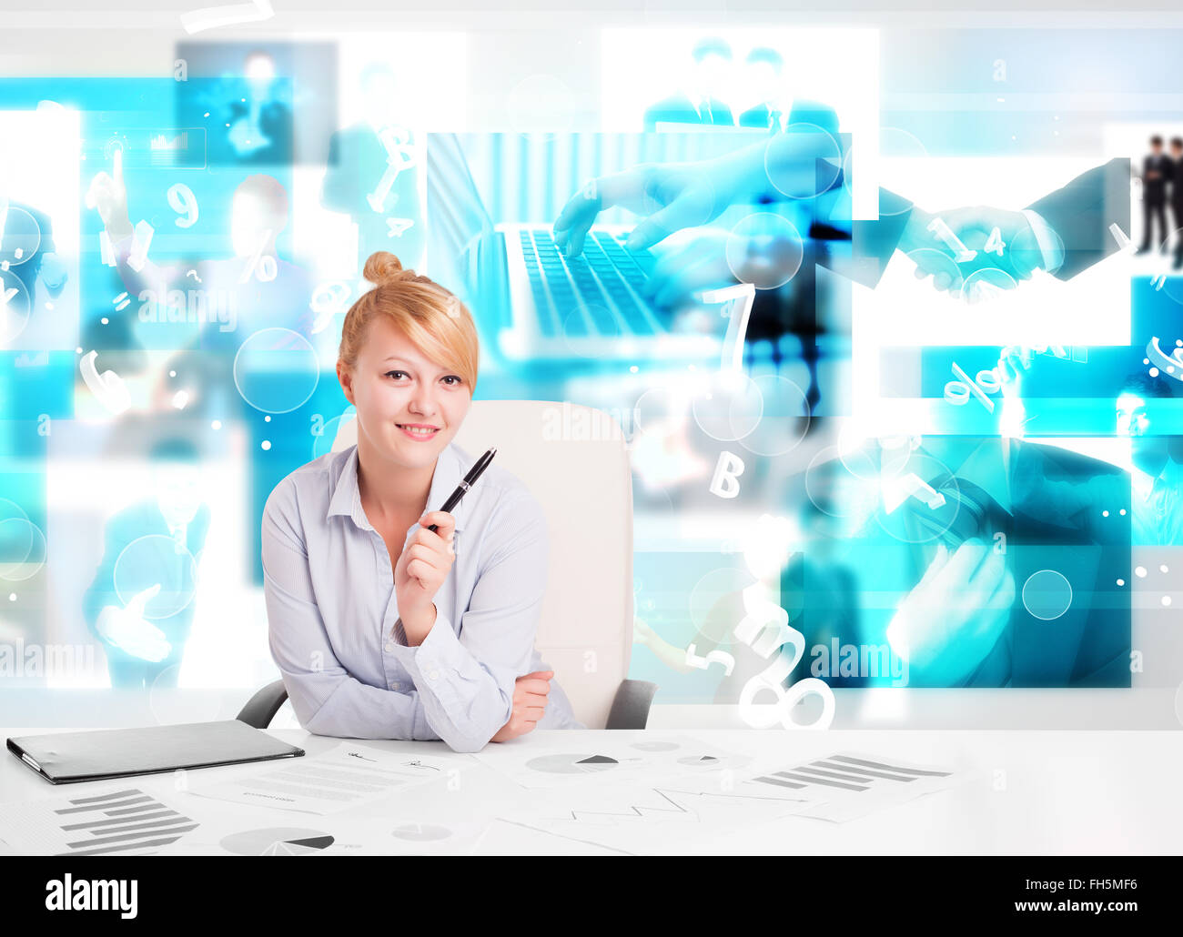 Business person at desk with modern tech images at background Stock ...