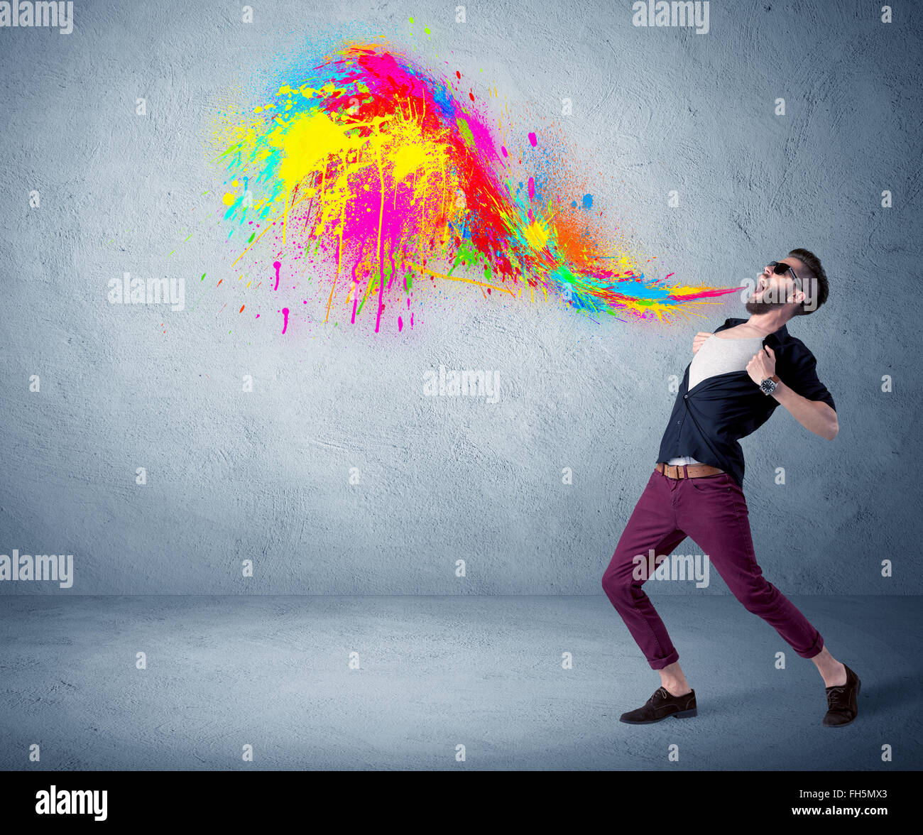 Hipster guy shouting colorful paint on wall Stock Photo - Alamy