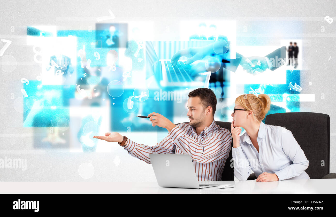 Business persons at desk with modern tech images at background Stock ...