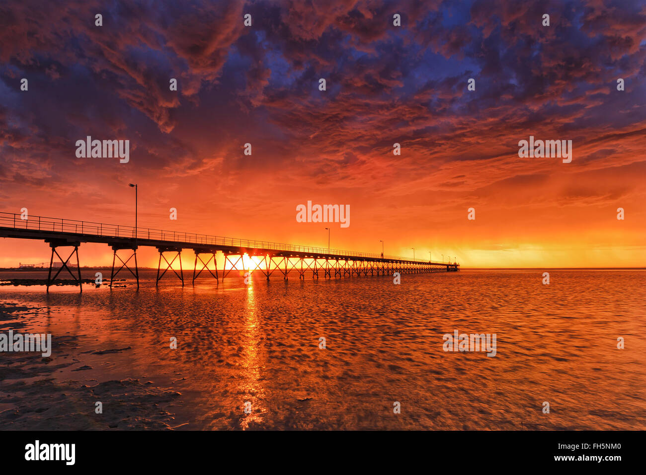 timber jetty in small coastal town Ceduna during severe storm at orange ...