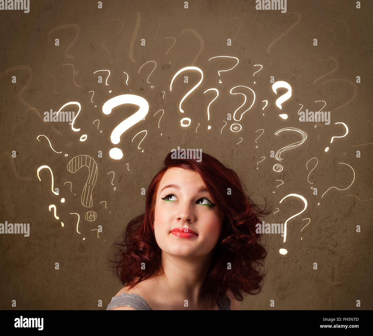 girl with question mark symbols around her head Stock Photo - Alamy