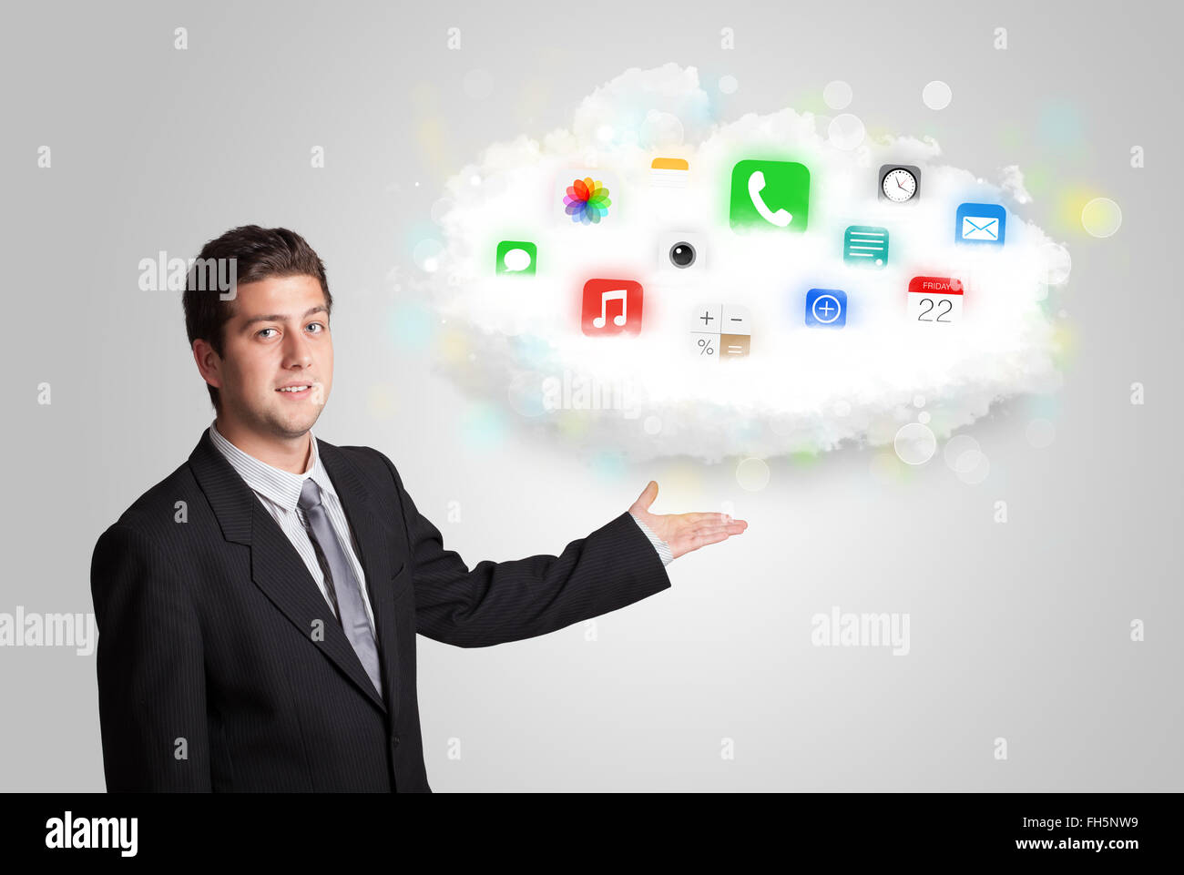 Young man presenting cloud with colorful app icons and symbols Stock ...