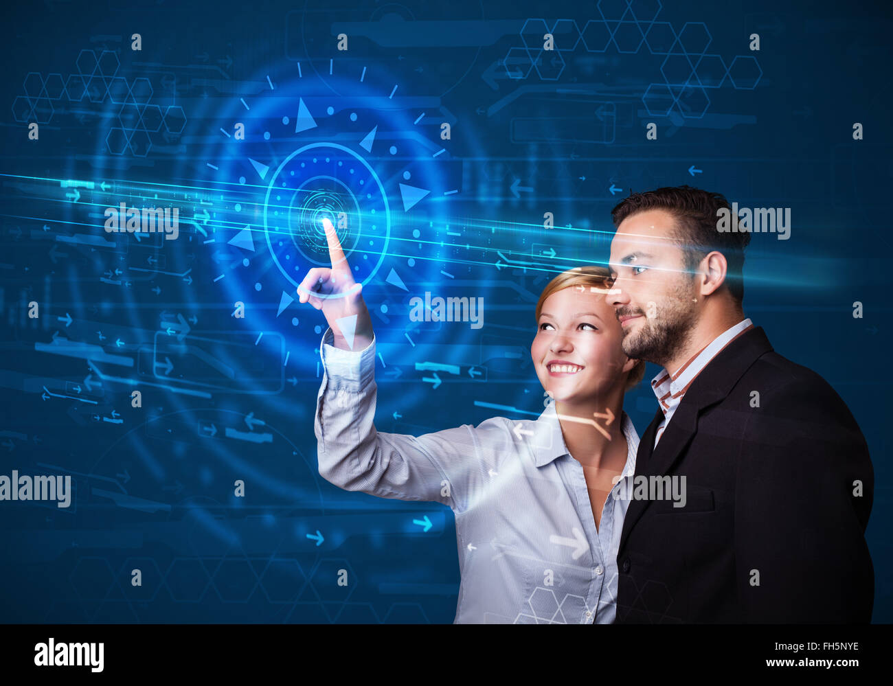 Young tech couple pressing high technology control panel screen concept ...