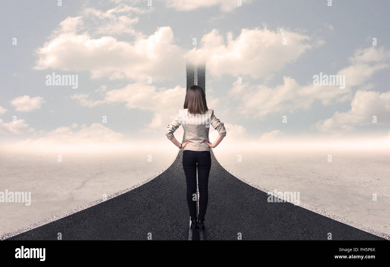 Business woman looking at road that goes up in the sky Stock Photo - Alamy