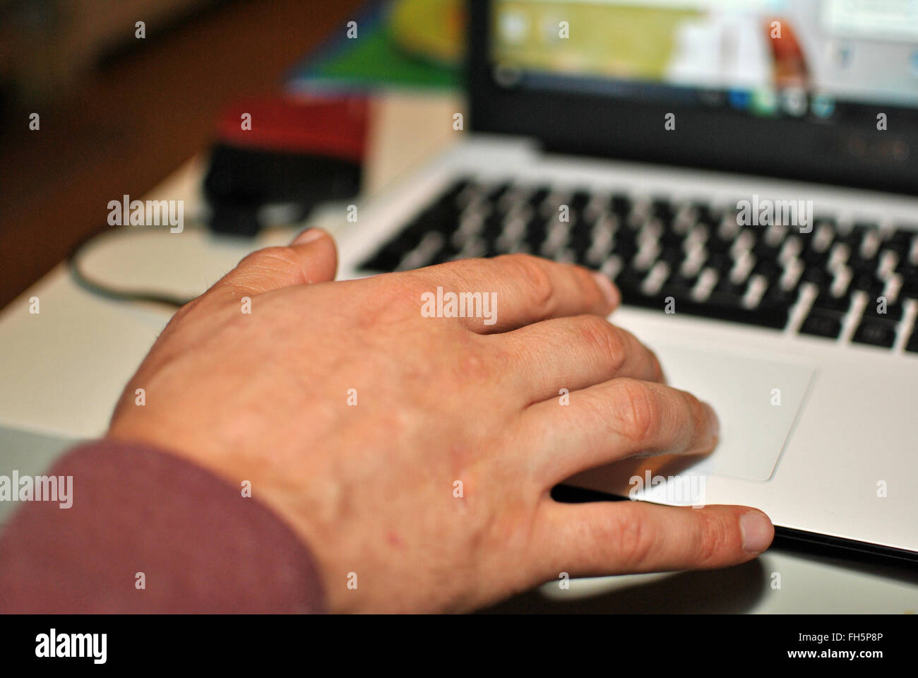 hand and laptop Stock Photo - Alamy