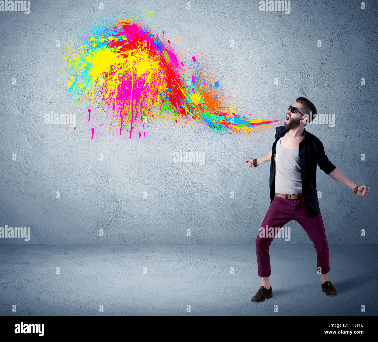 Hipster guy shouting colorful paint on wall Stock Photo - Alamy